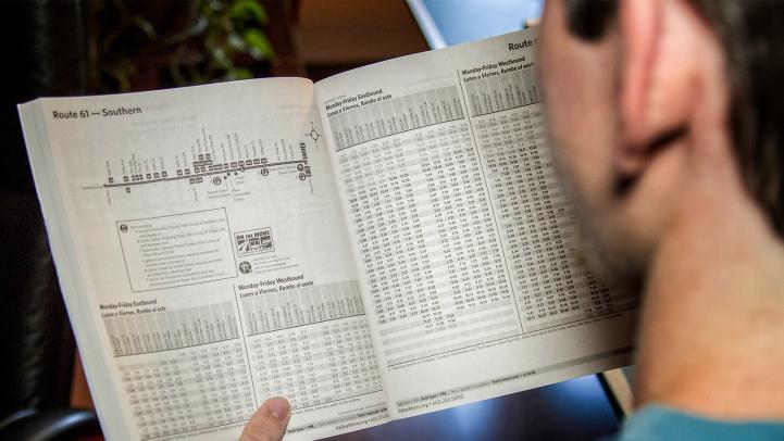 Man reading transit book