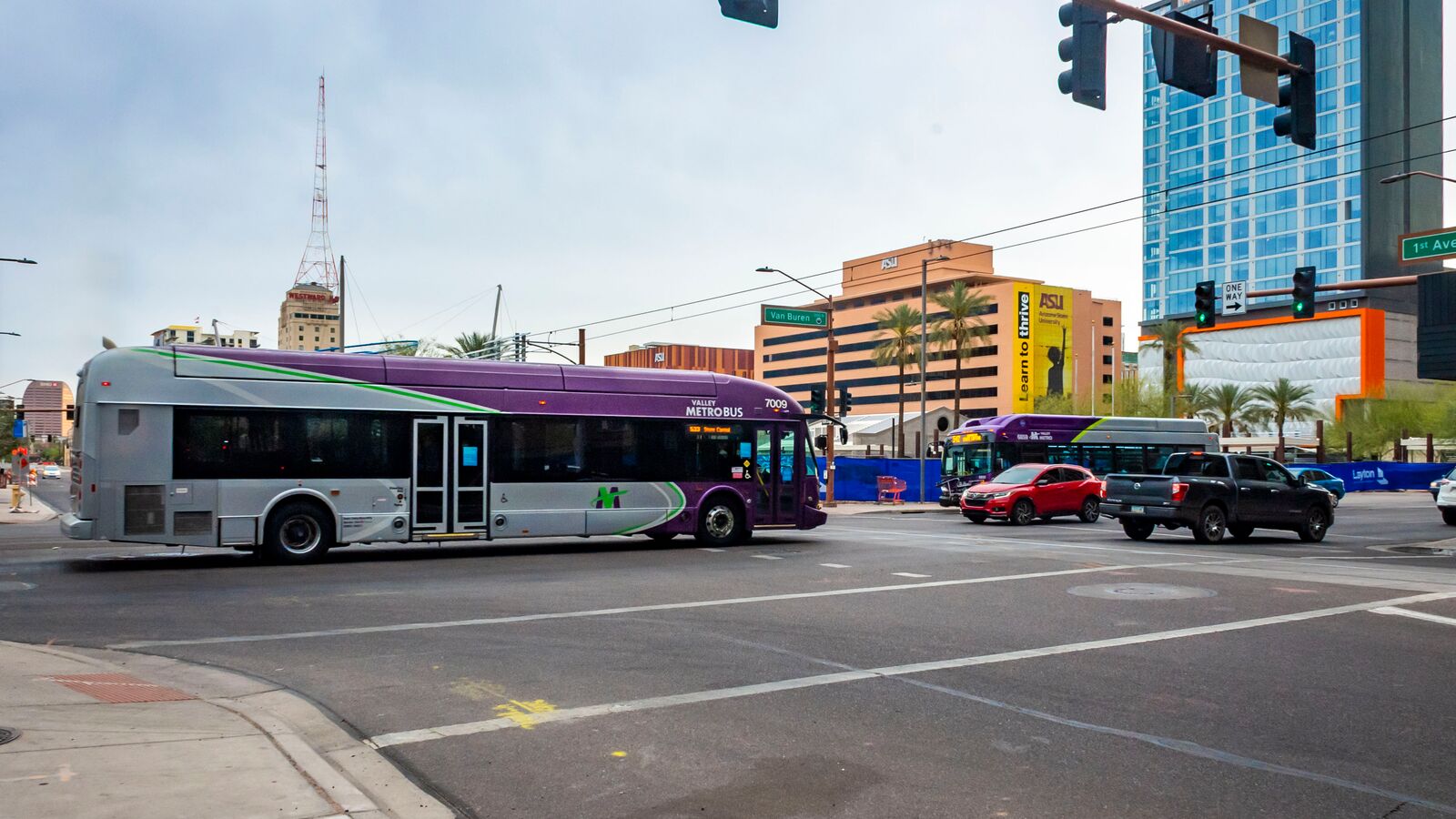 An eastbound bus and a westbound bus pass each other at 1st Ave and Van ...