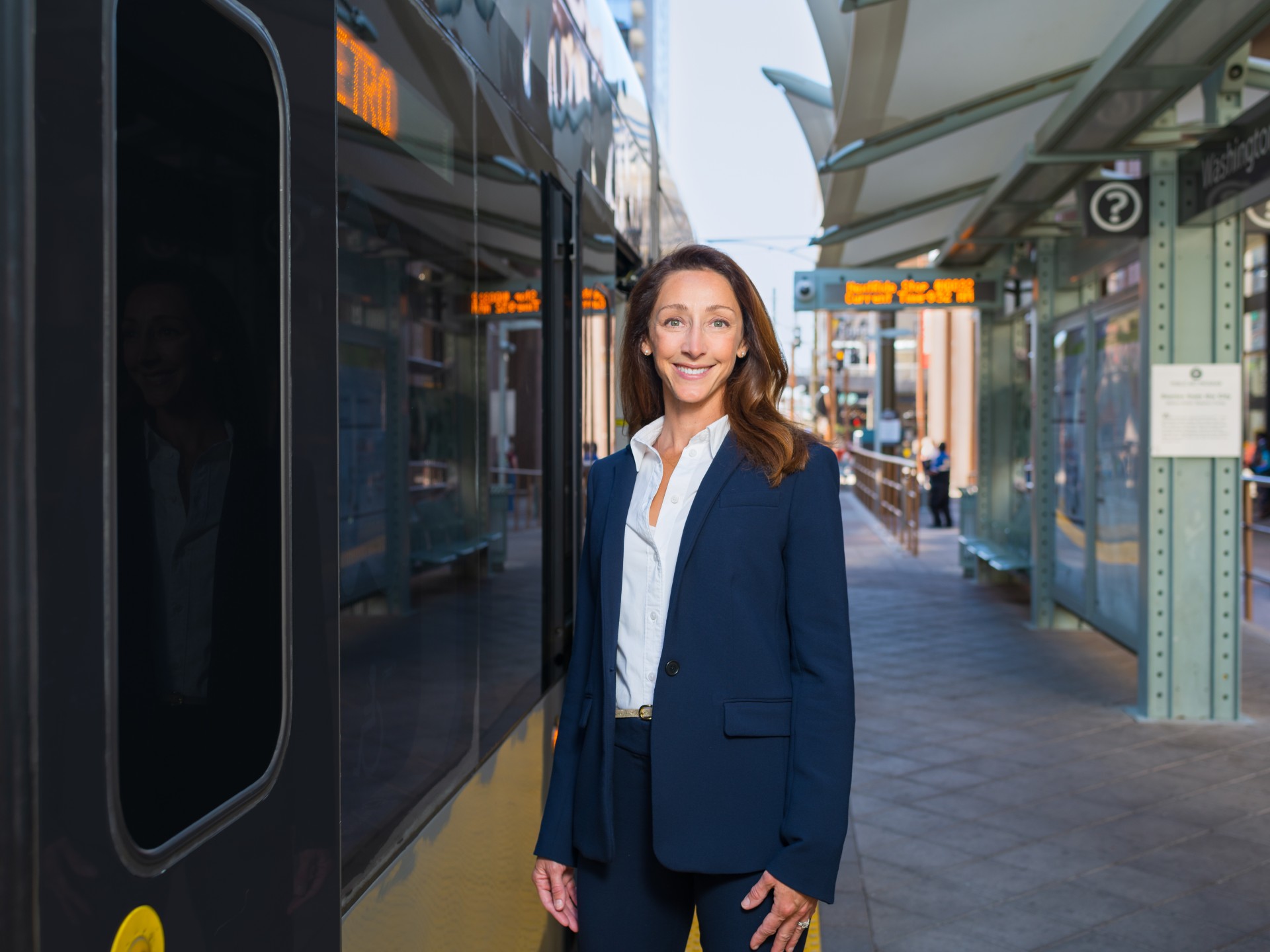 Valley Metro CEO Jessica Mefford-Miller next to a light rail train