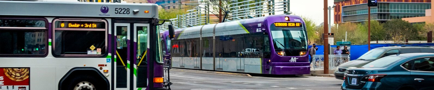 How To Ride. Picture of light rail train near bus at intersection