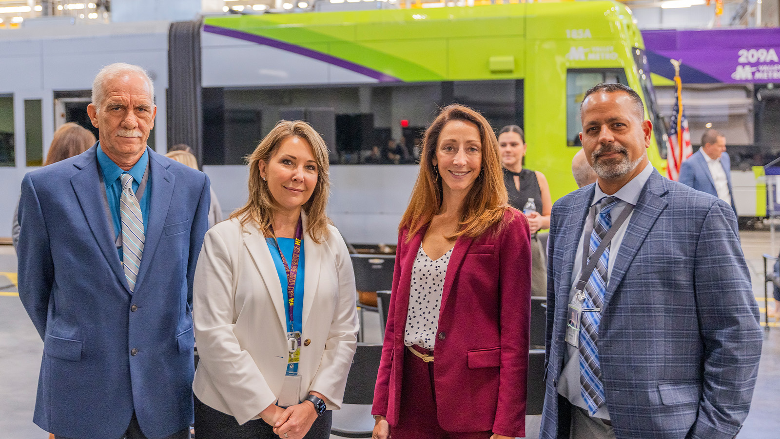 Valley Metro CEO and staff standing near streetcar