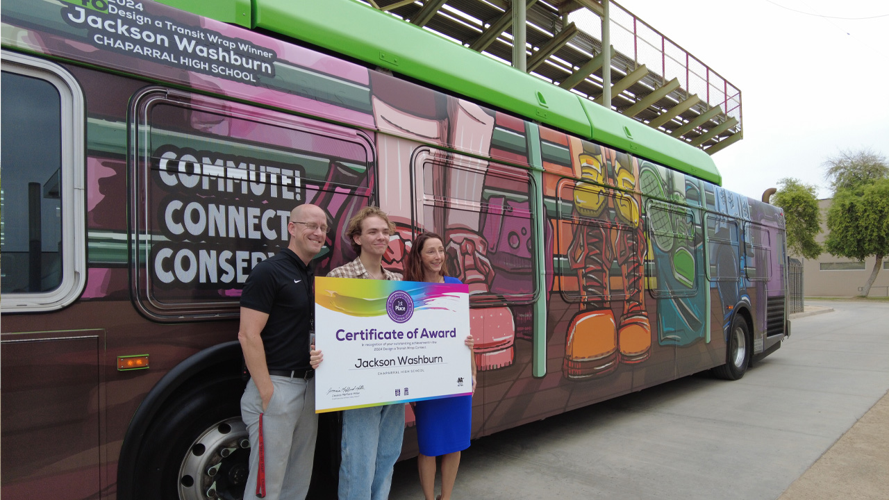 2024 Design a Transit Wrap Contest winner Jackson smiling. Behind him ...