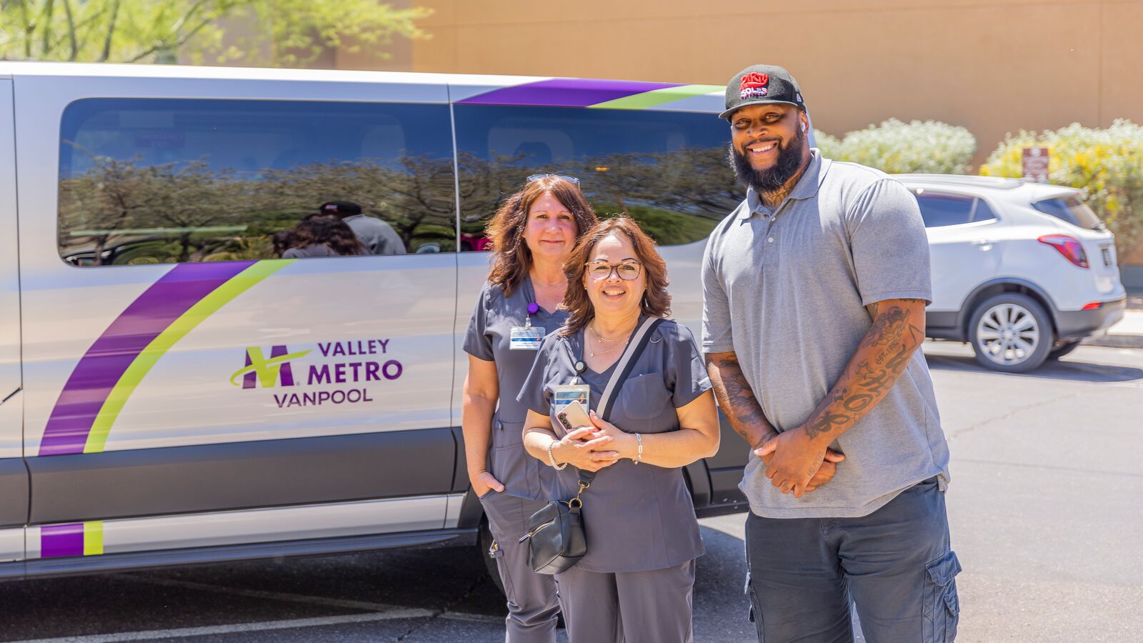 Three people near a Valley Metro vanpool van
